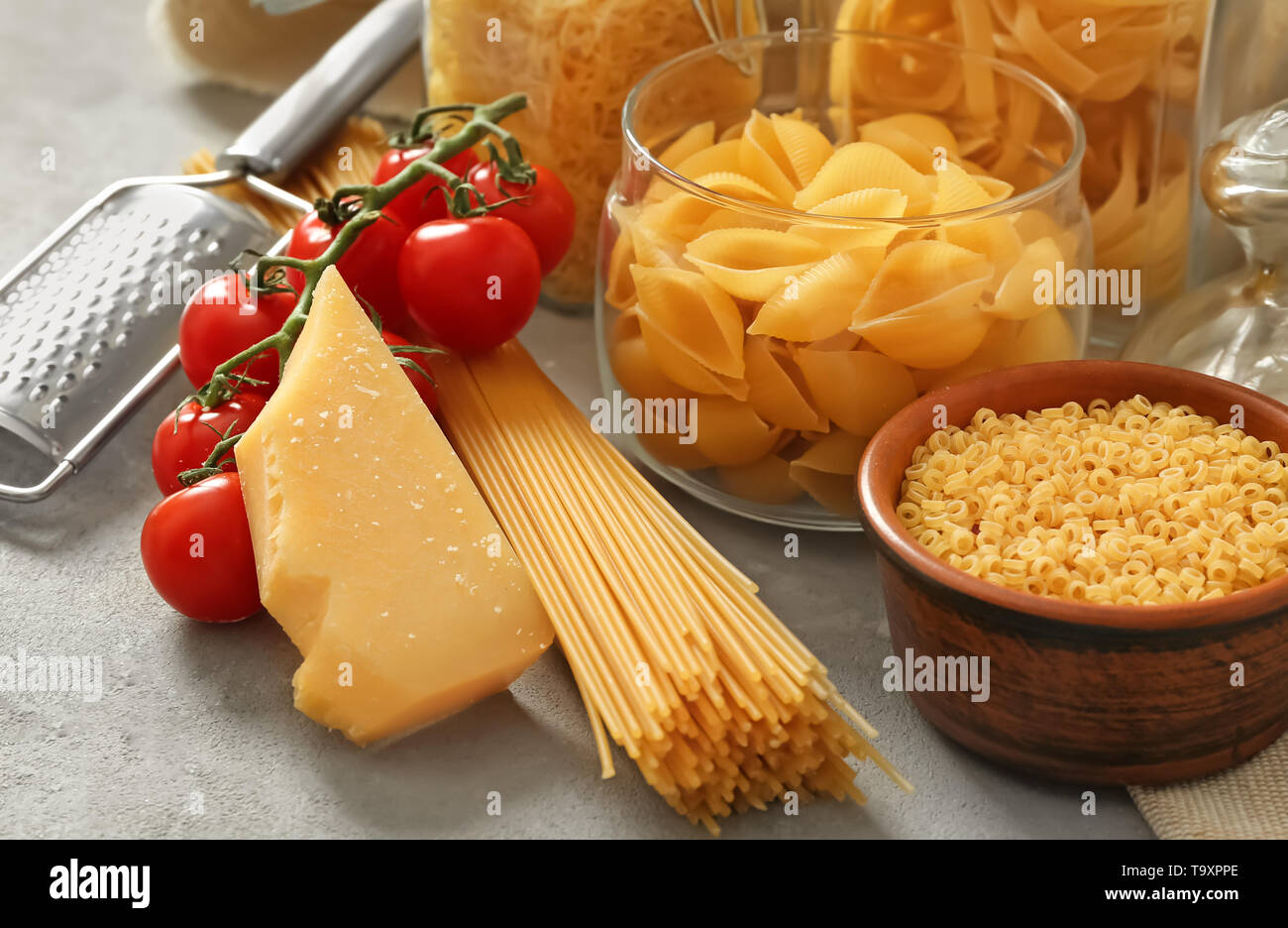Assorted pasta on grey table Stock Photo - Alamy
