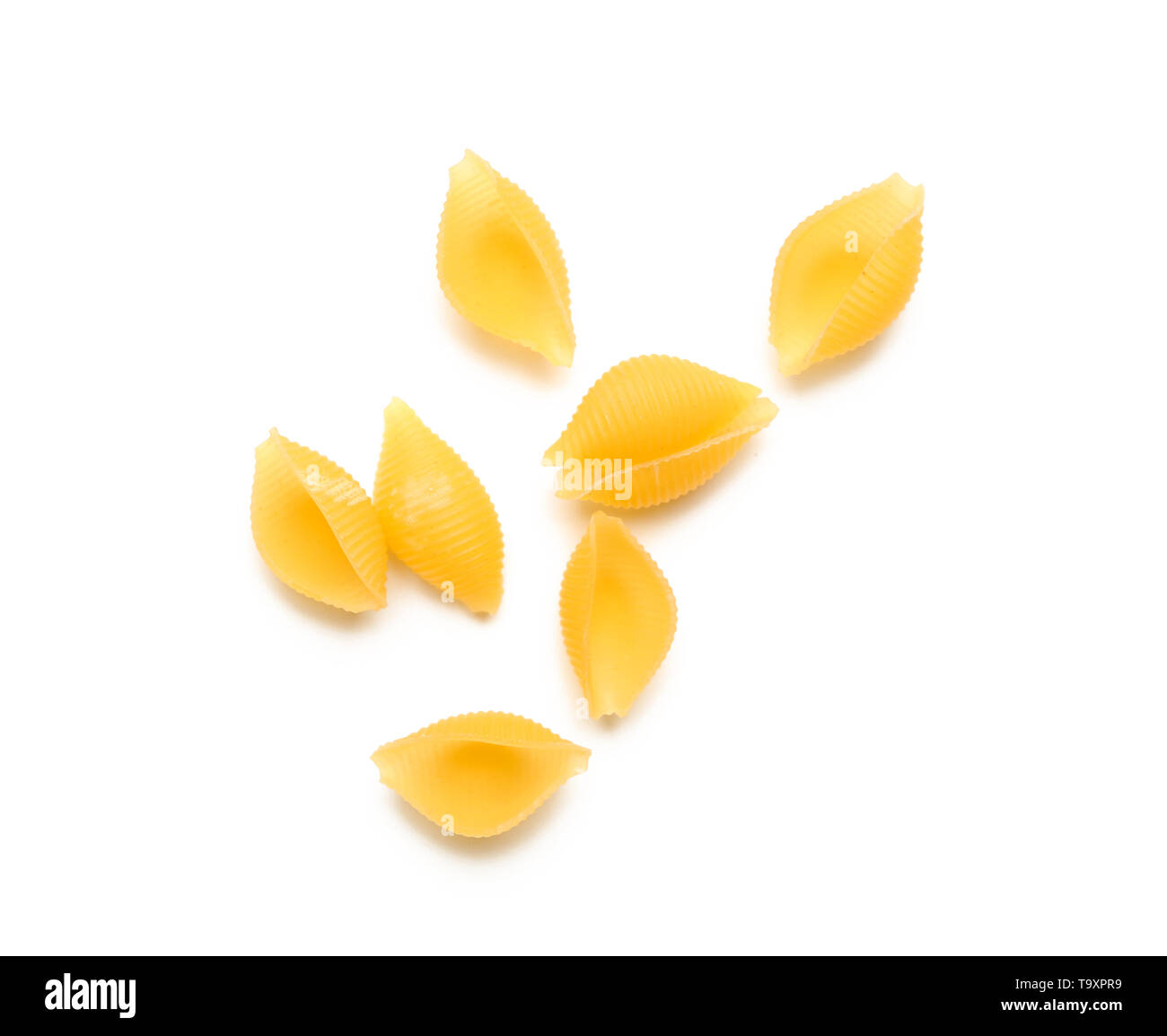 Raw conchiglie pasta on white background Stock Photo - Alamy