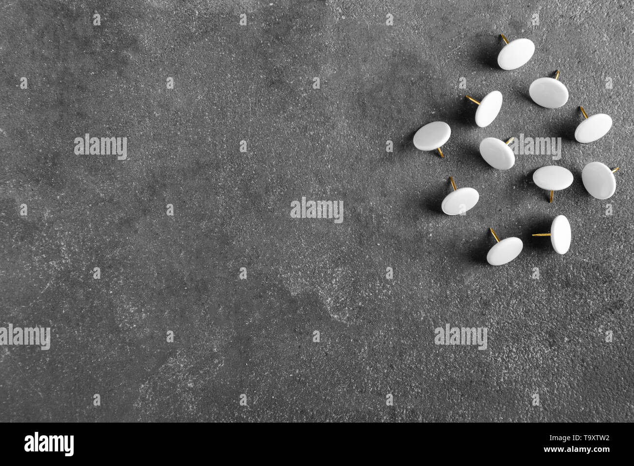 Drawing pins on grey background Stock Photo - Alamy
