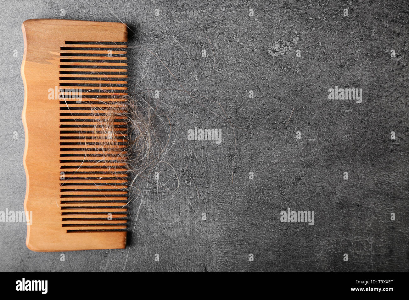 Comb with fallen down hair on grey background Stock Photo - Alamy