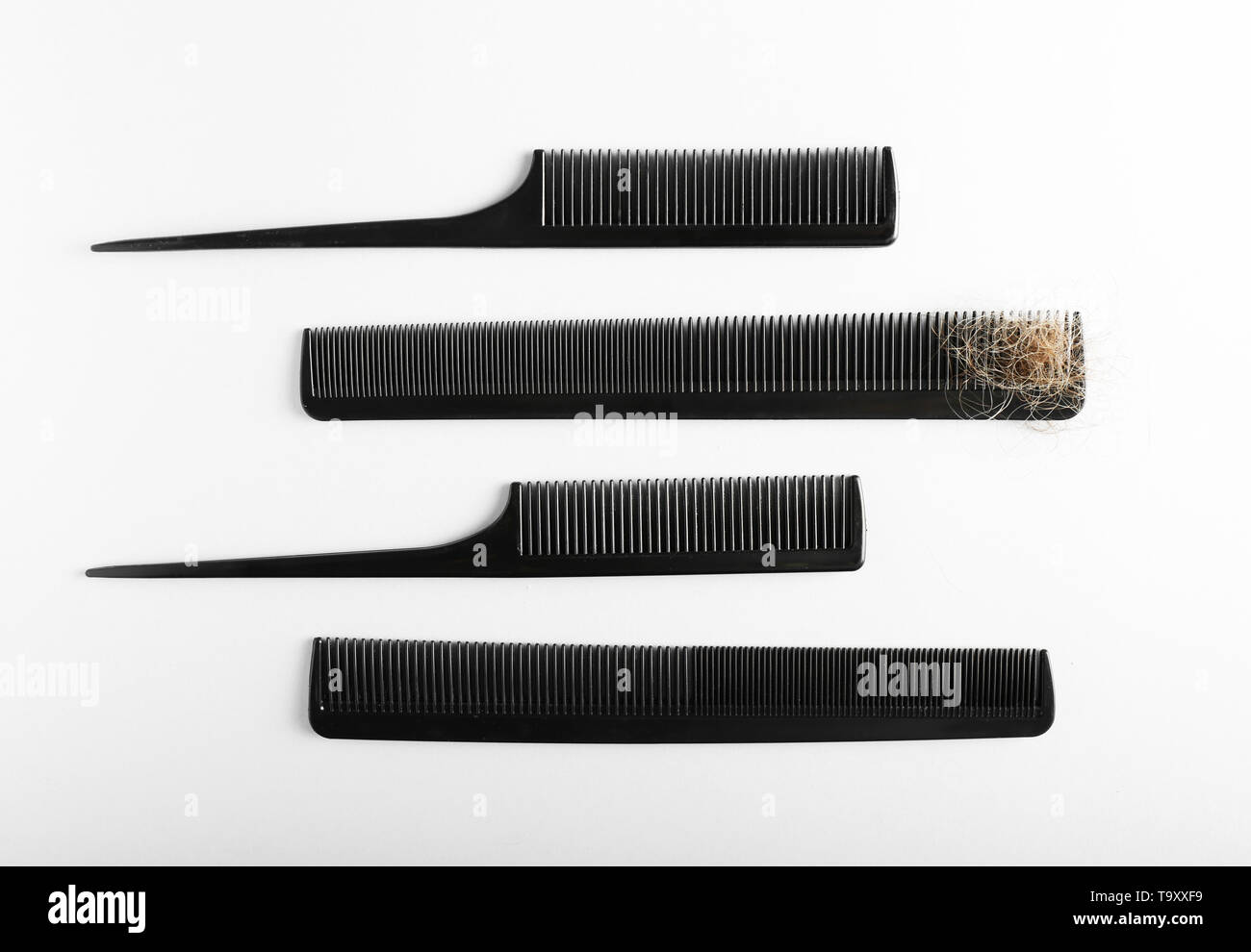 Combs with fallen down hair on white background Stock Photo - Alamy