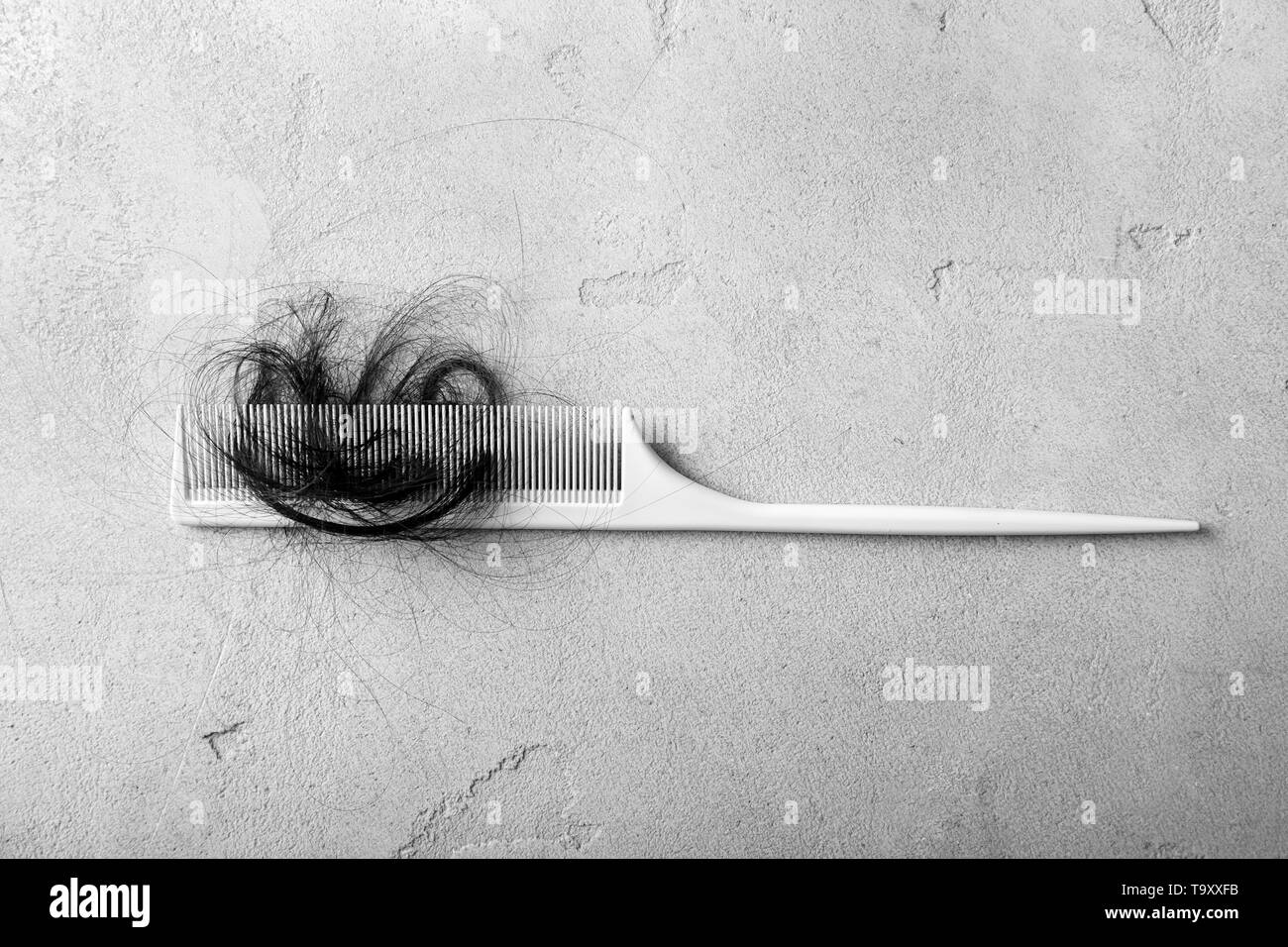 Comb with fallen down hair on grey background Stock Photo - Alamy