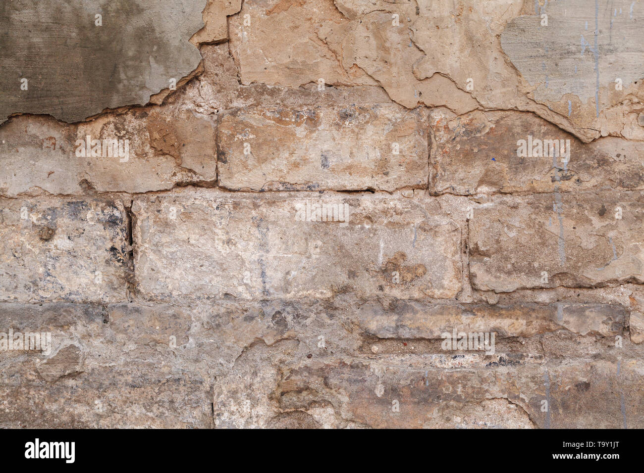 Old ruined wall facade with fallen cement and bricks. Texture ...