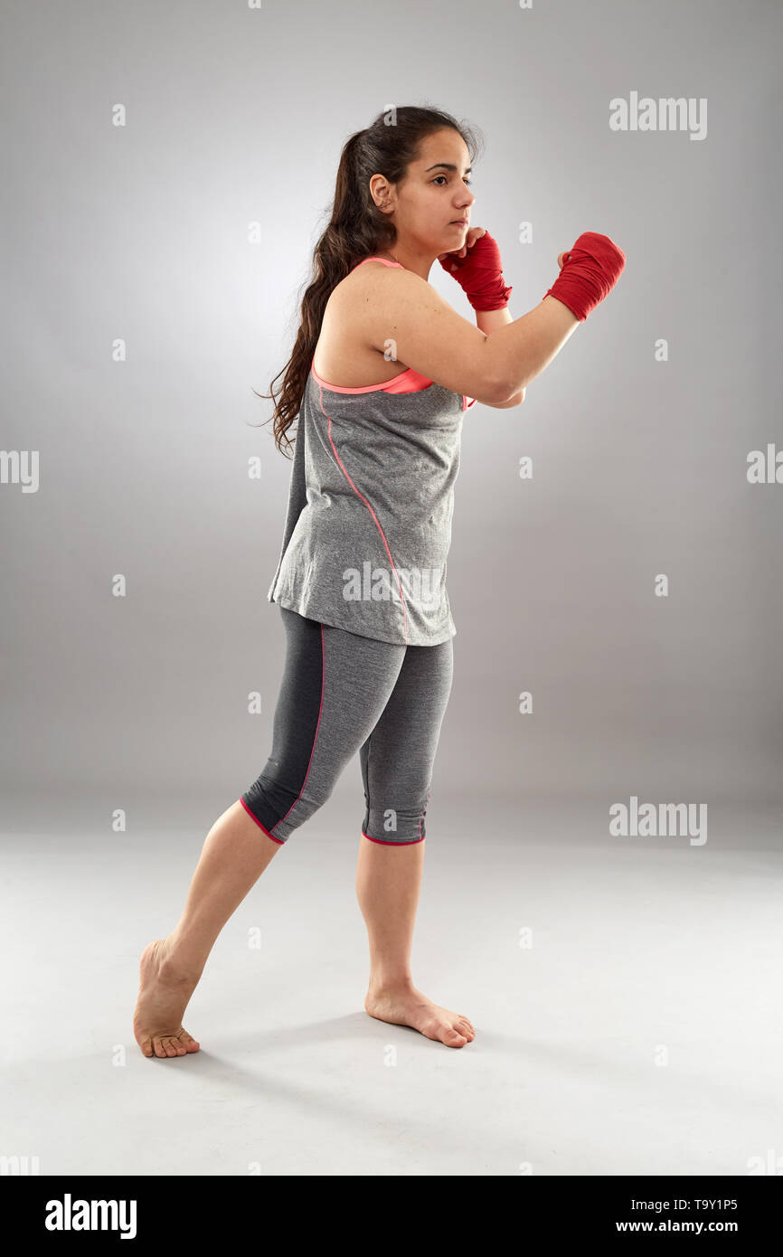 Young kickboxing female fighter in hand wraps, barefoot Stock Photo - Alamy