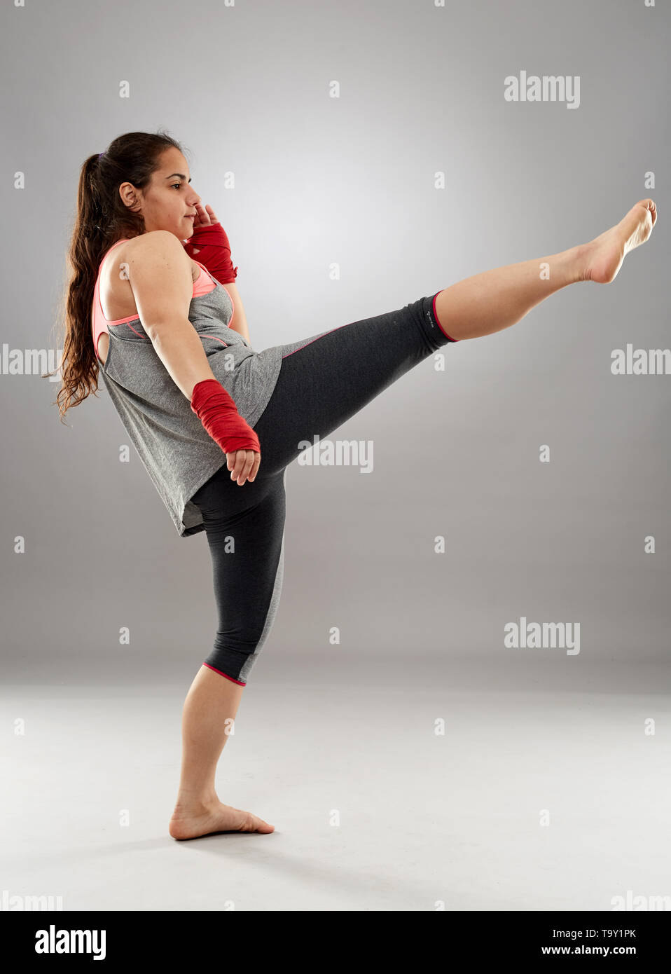 Young kickboxing female fighter in hand wraps, barefoot Stock Photo - Alamy