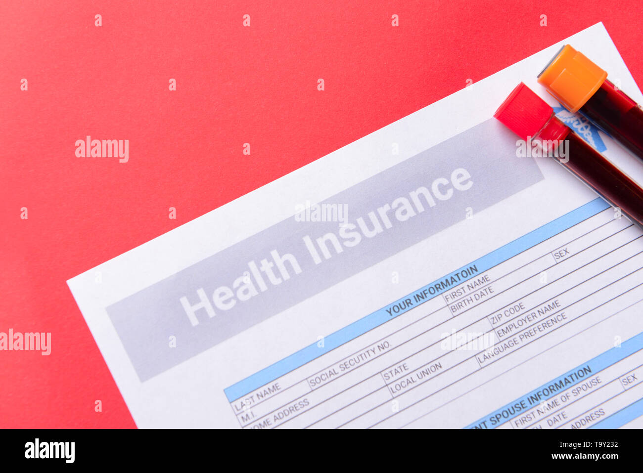 Health insurance form and test-tubes with blood on color background ...