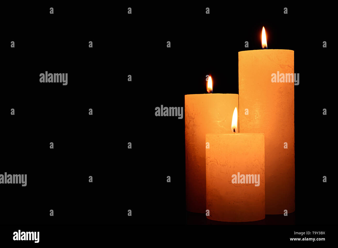 Beautiful burning candles on dark background Stock Photo - Alamy