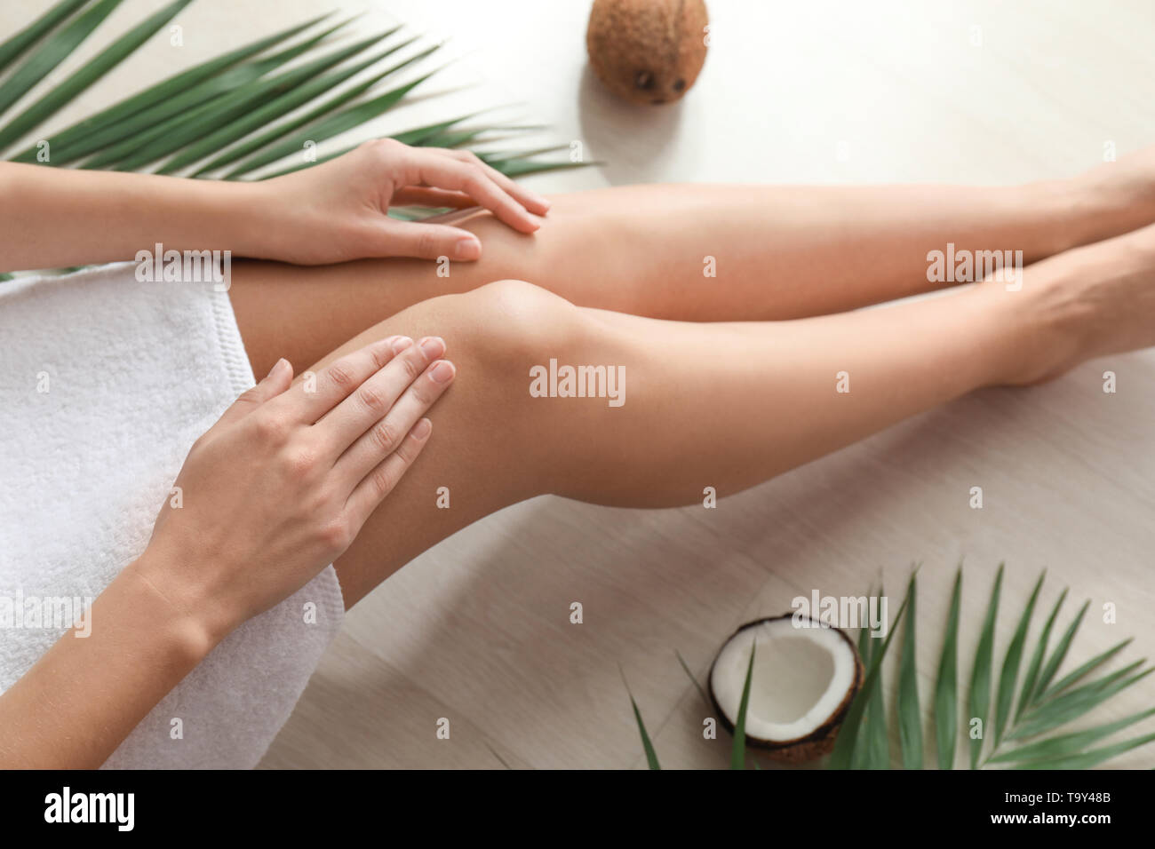 Woman applying oil legs hi-res stock photography and images - Alamy