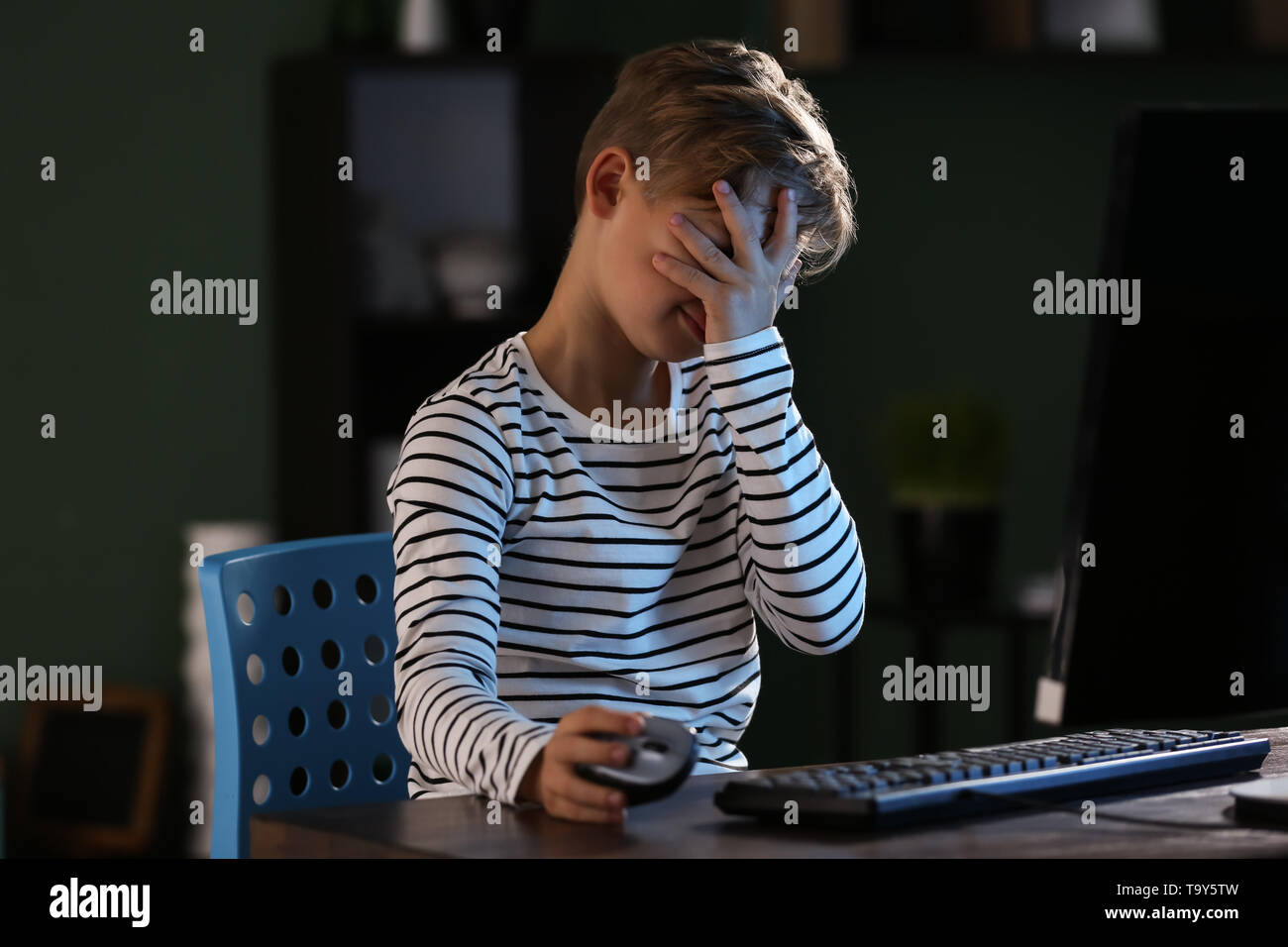 Cute little boy after losing computer game at home Stock Photo - Alamy
