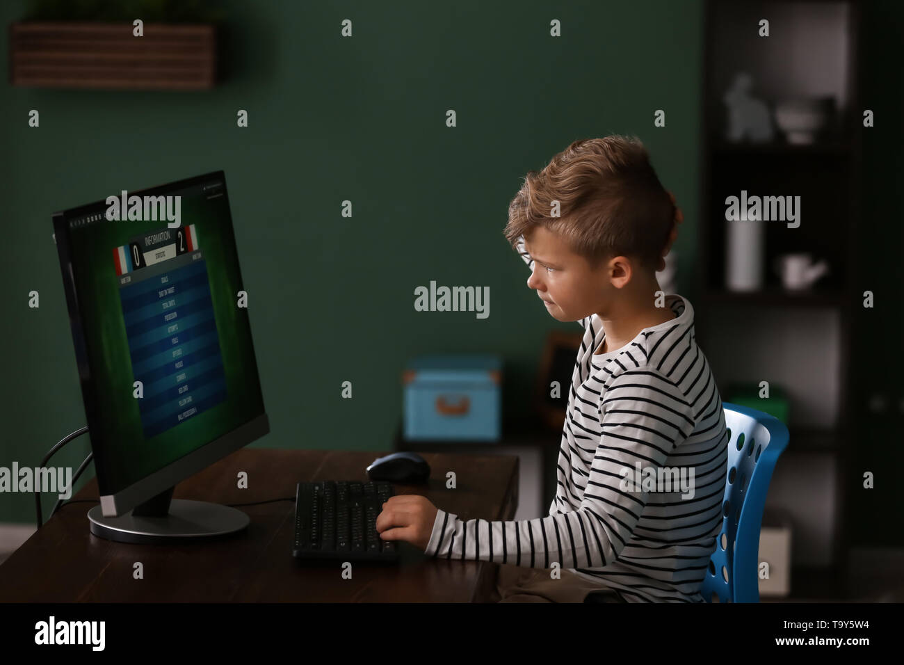 Cute little boy playing computer game at home Stock Photo - Alamy