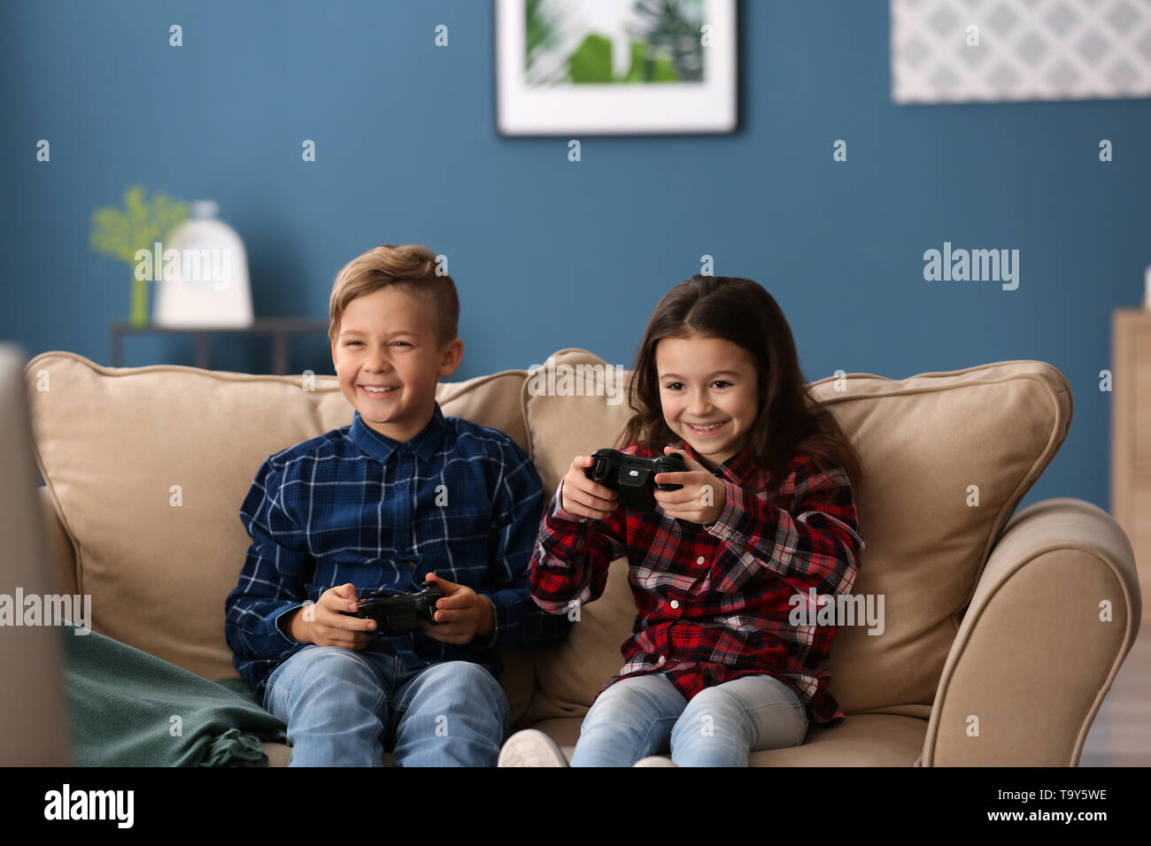 Cute little children playing computer game at home Stock Photo - Alamy