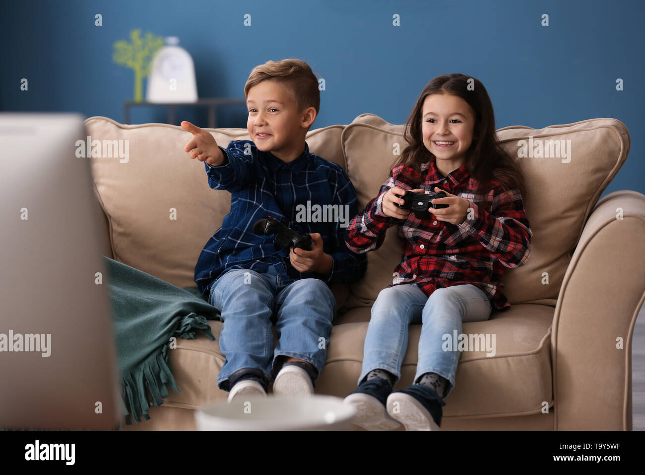 Cute little children playing computer game at home Stock Photo - Alamy