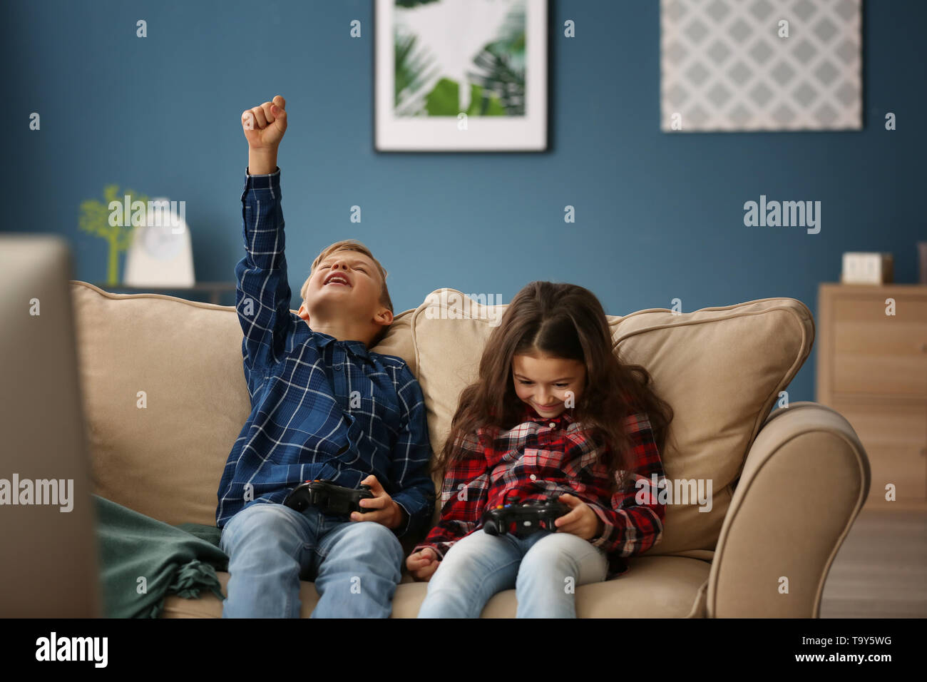 Little children playing computer game at home Stock Photo - Alamy