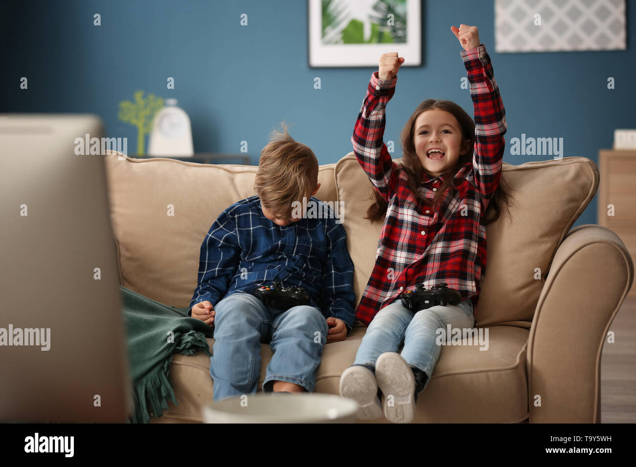 Little children playing computer game at home Stock Photo - Alamy