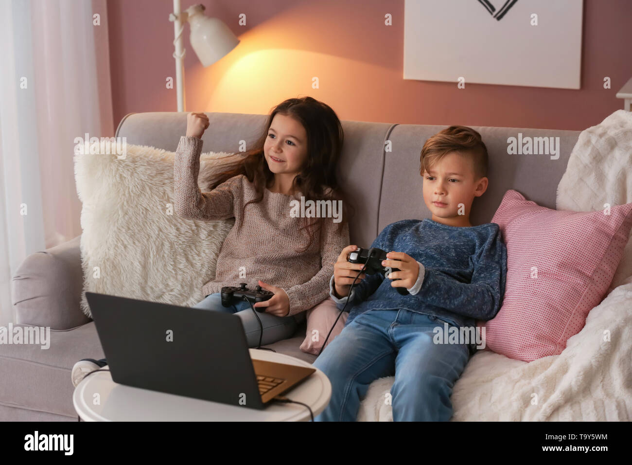 Little children playing computer game at home Stock Photo - Alamy