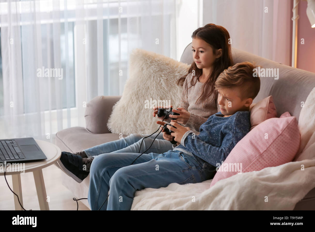 Cute little children playing computer game at home Stock Photo - Alamy