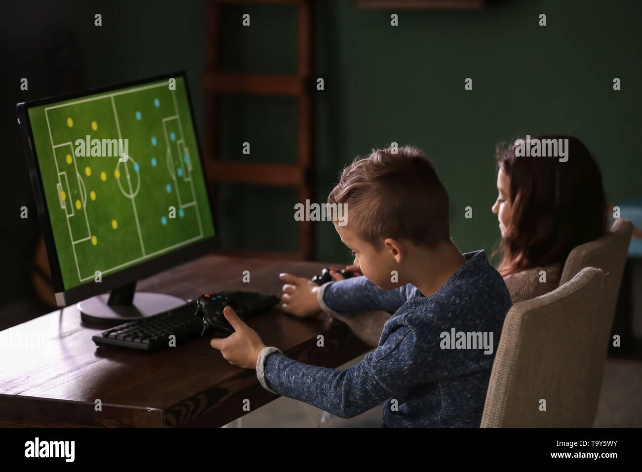 Cute little children playing computer game at home Stock Photo - Alamy
