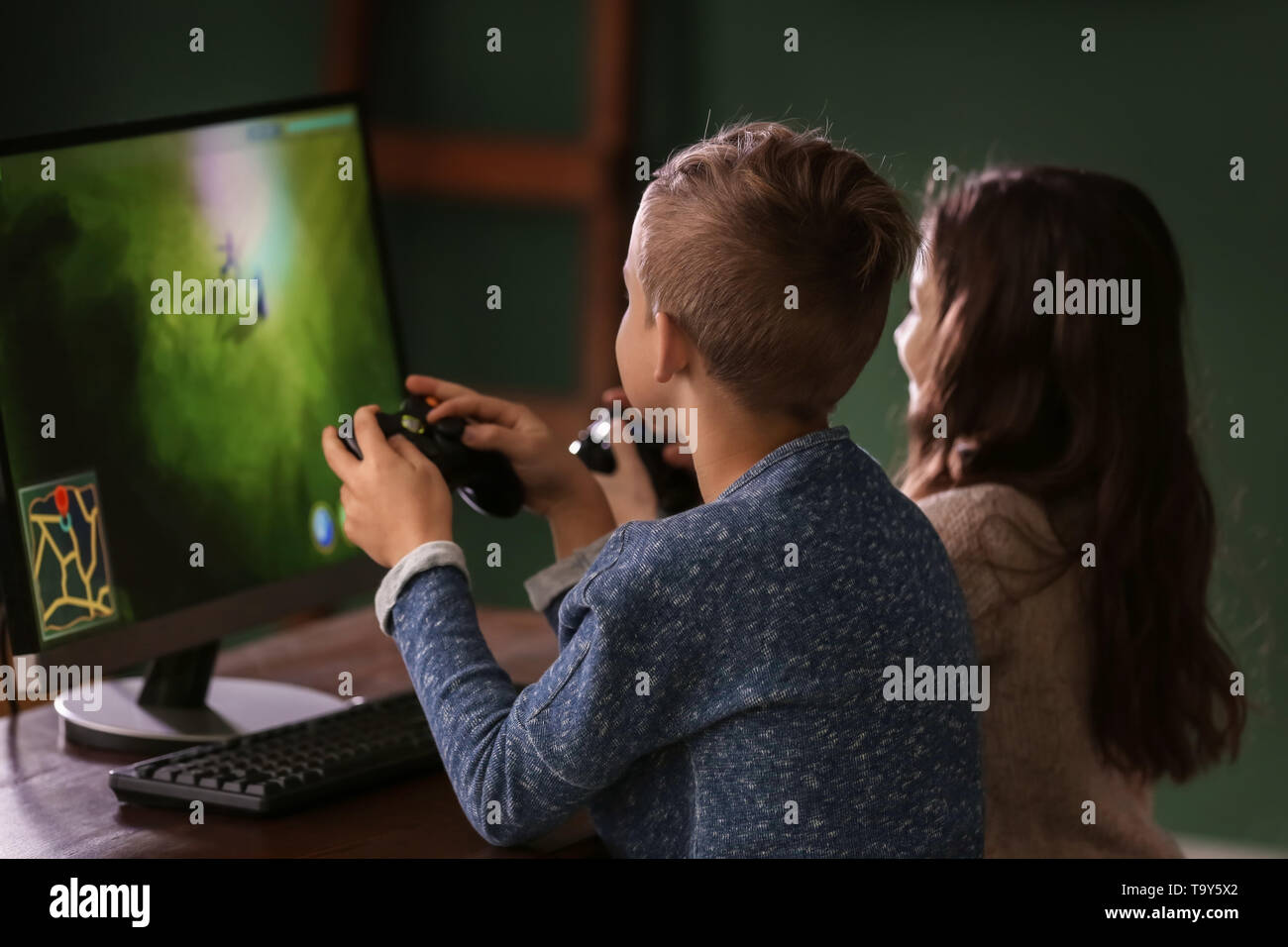 Cute little children playing computer game at home Stock Photo - Alamy