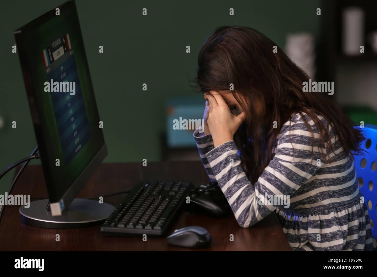 Cute little girl after losing computer game at home Stock Photo - Alamy