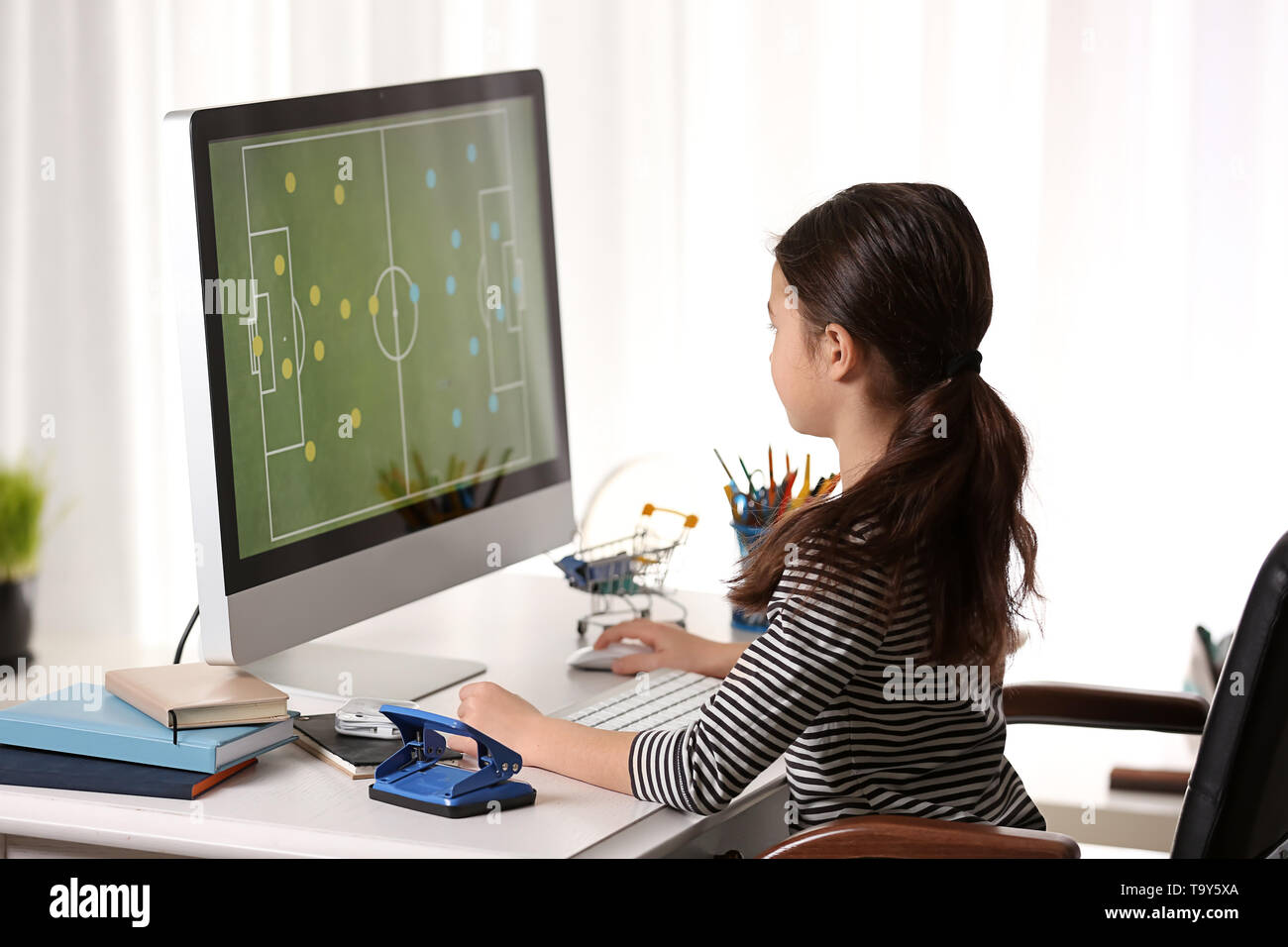 Cute little girl playing computer game at home Stock Photo - Alamy