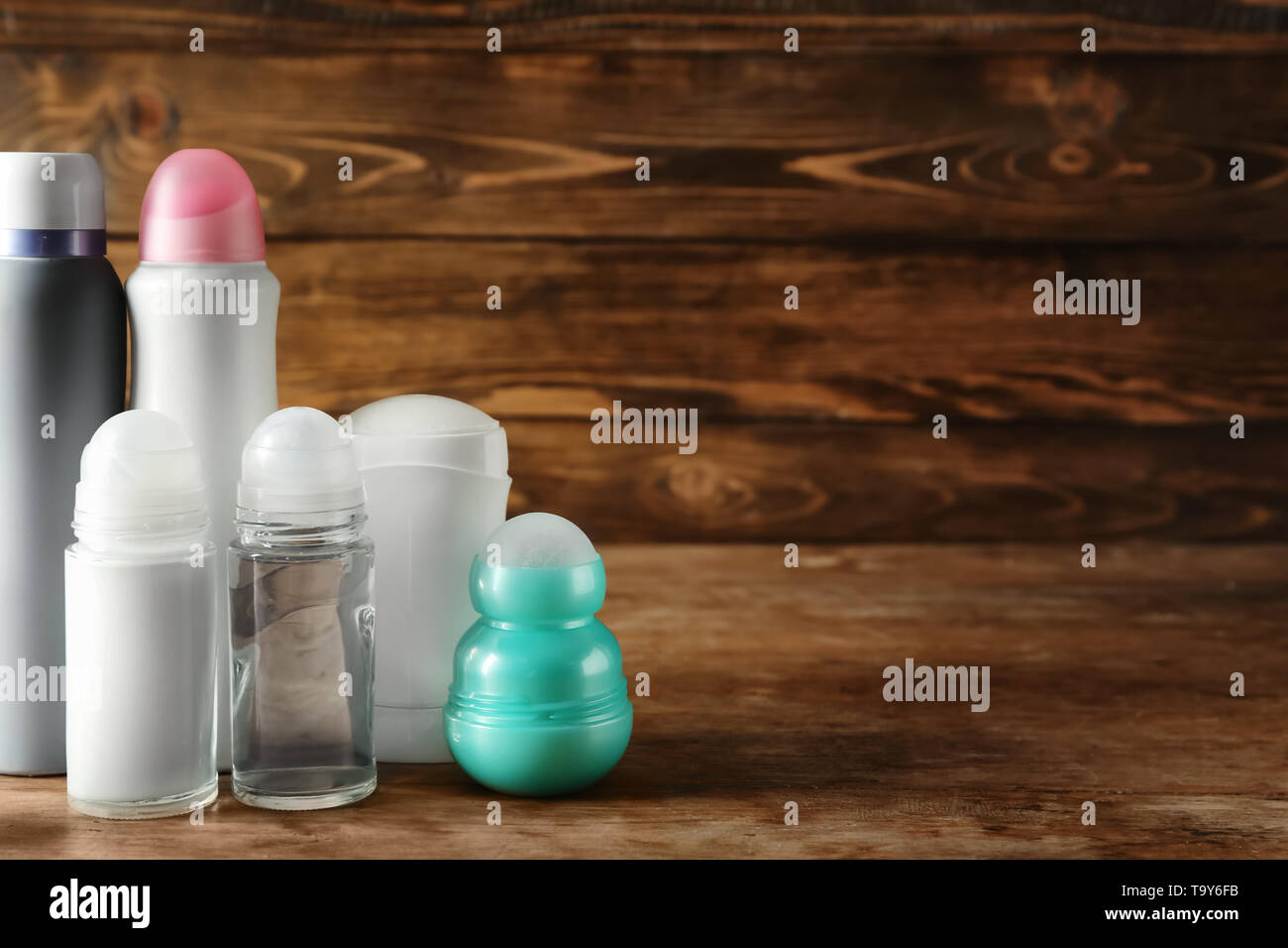 Different deodorants on wooden background Stock Photo - Alamy