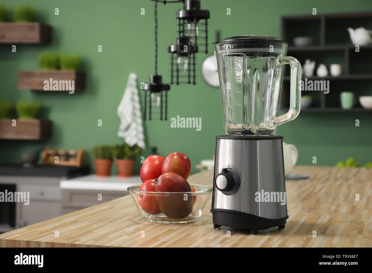 Modern blender with fresh mango on wooden table in kitchen Stock Photo ...