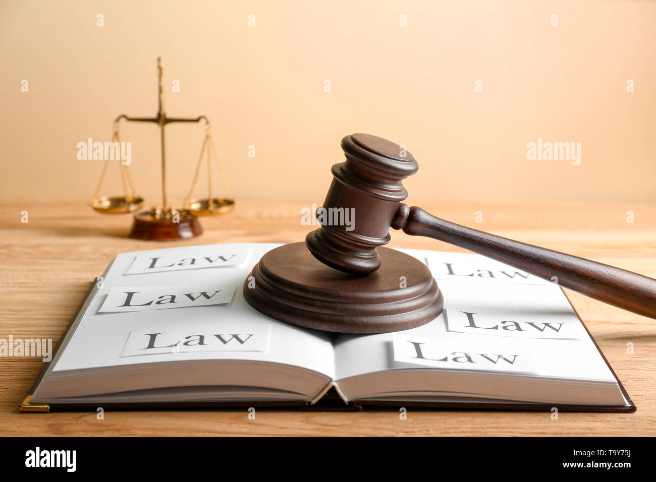 Judge's gavel and open book on wooden table Stock Photo - Alamy