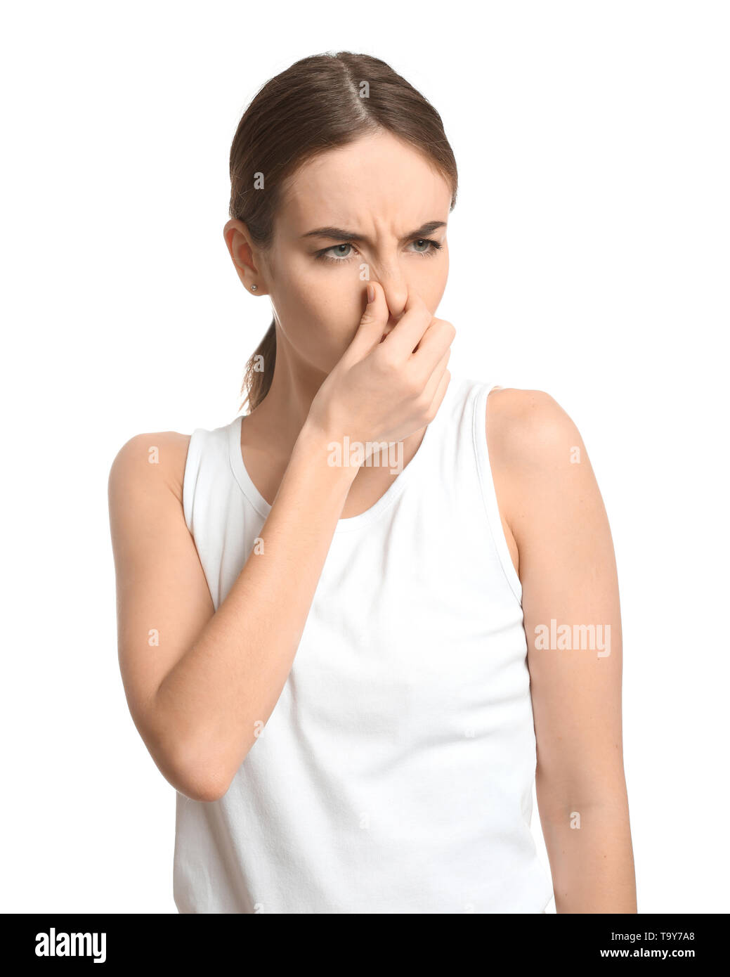 Beautiful young woman feeling smell of sweat on white background ...