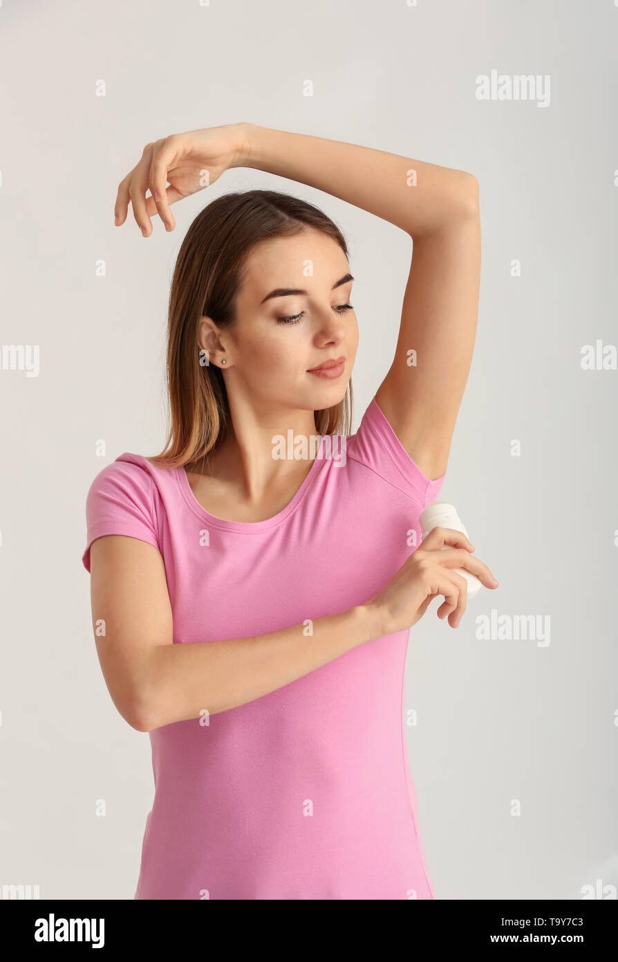 Woman using roll on deodorant hi-res stock photography and images - Alamy