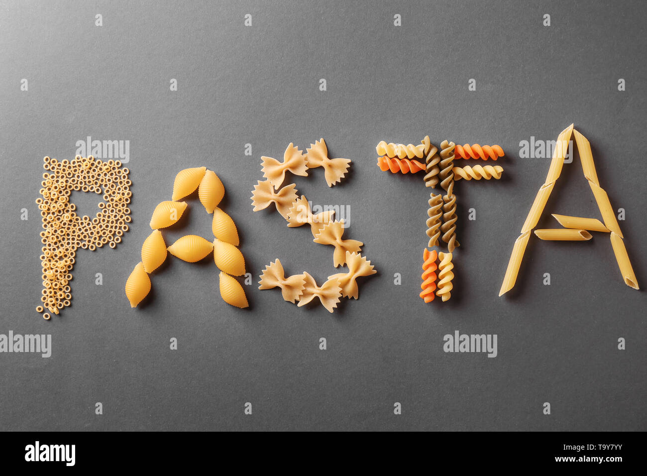 Word PASTA on grey background Stock Photo - Alamy