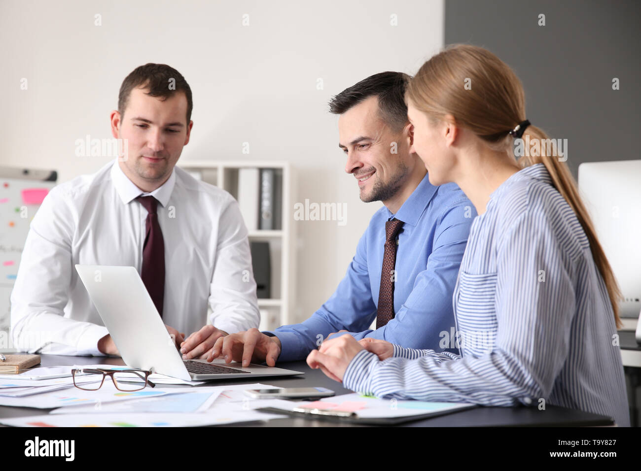 Young colleagues working together in modern office Stock Photo - Alamy