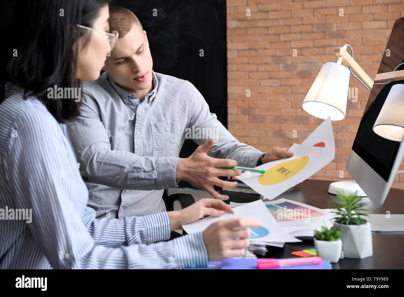 Designers working on new logo in office Stock Photo - Alamy