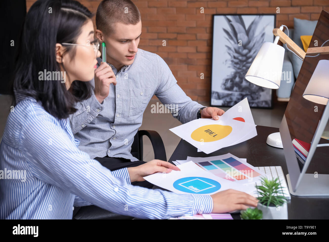 Designers working on new logo in office Stock Photo - Alamy