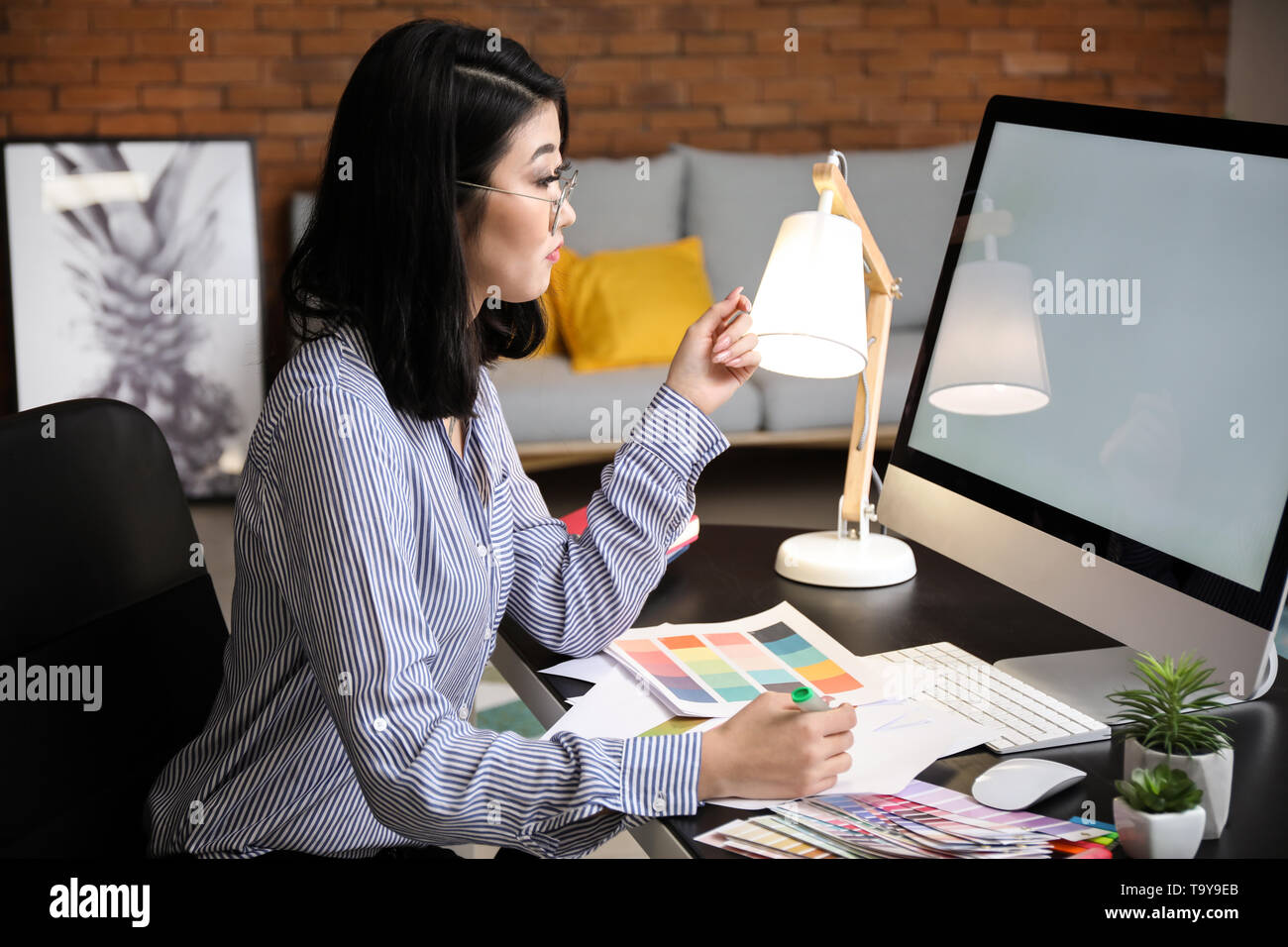 Female designer working on new logo in office Stock Photo - Alamy