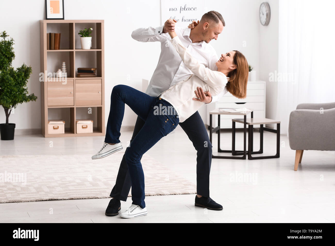 Beautiful couple dancing at home Stock Photo - Alamy