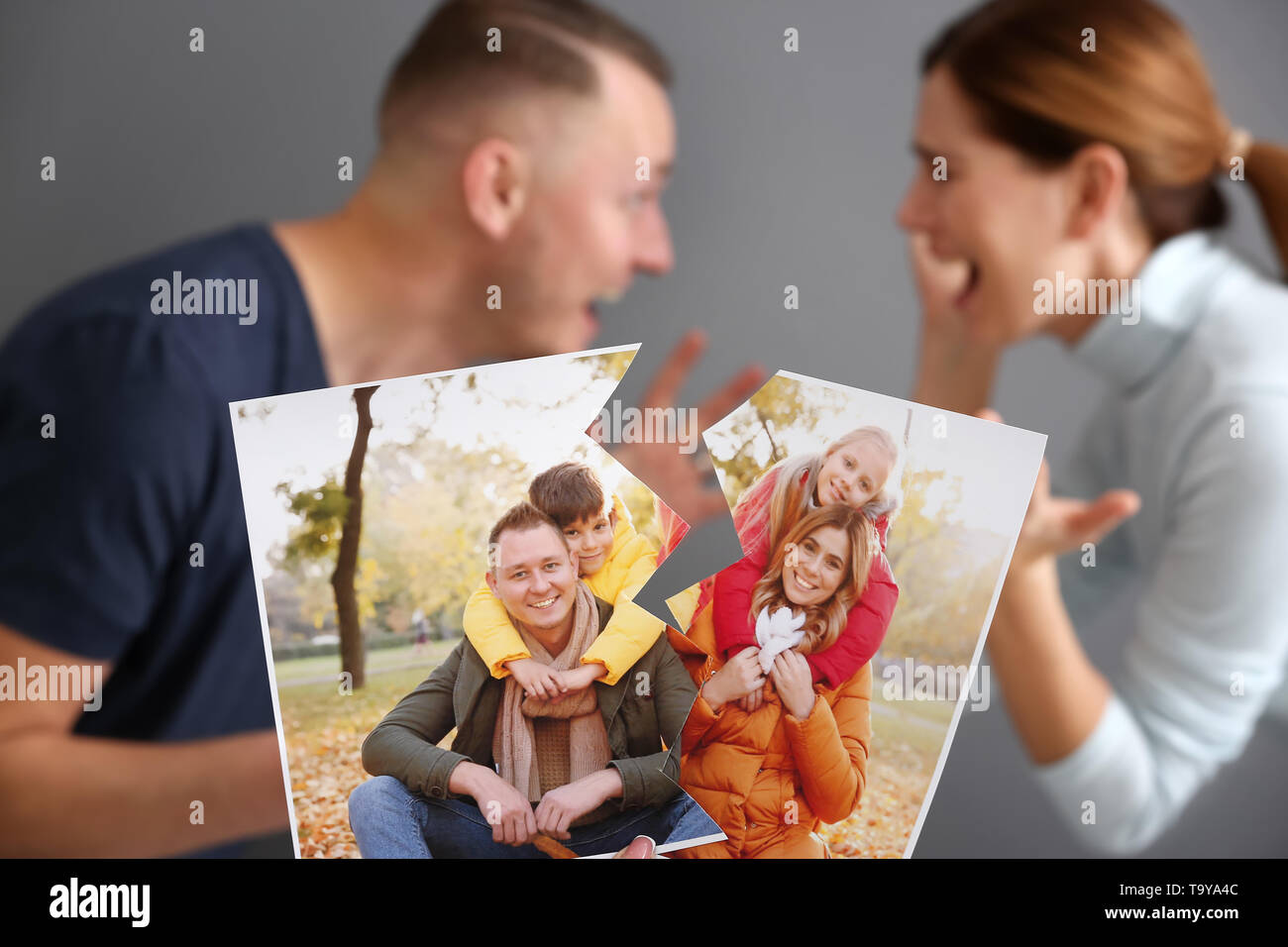 Unhappy couple with torn photo of theirs happy family. Concept of ...
