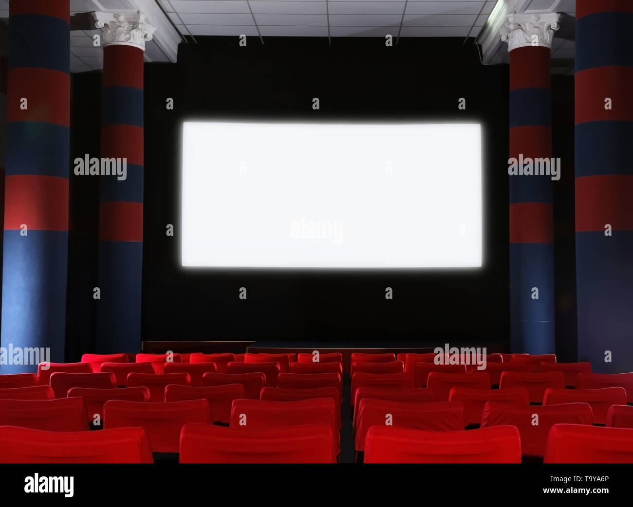 Empty cinema with large screen and comfortable chairs Stock Photo - Alamy