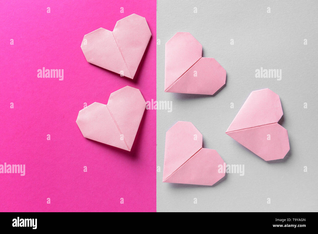 Origami hearts on color background Stock Photo - Alamy