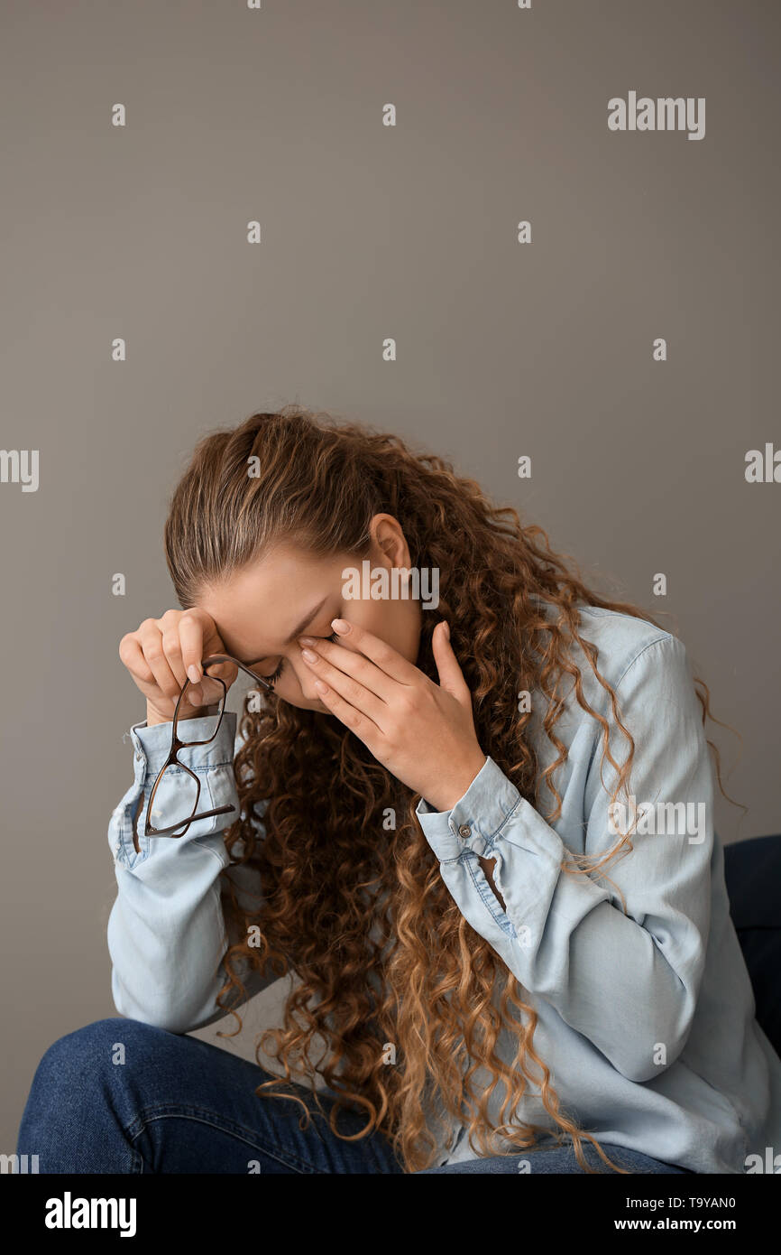 Portrait of woman with bad sight on grey background Stock Photo - Alamy