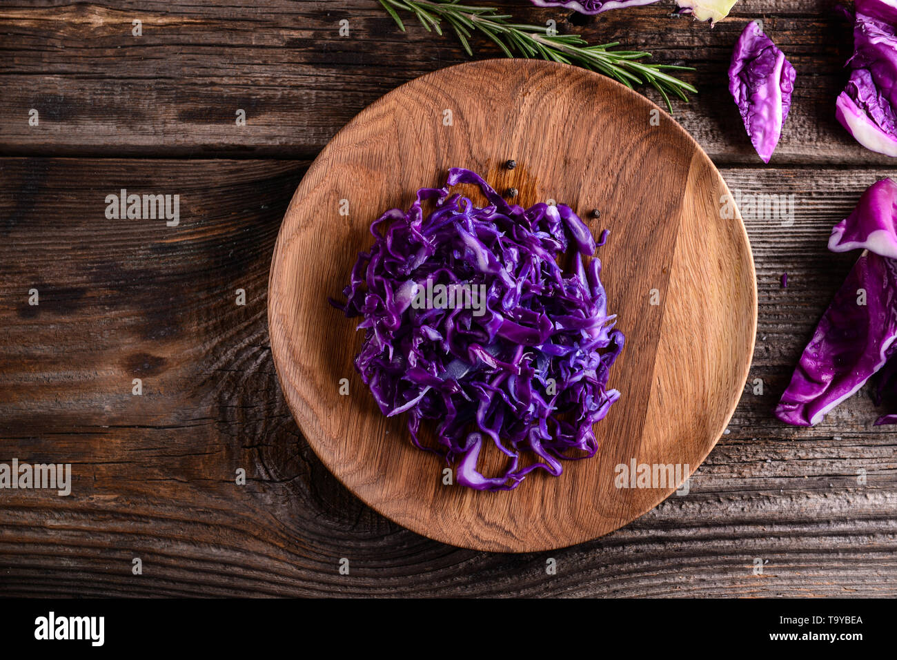 Wooden plate with tasty fermented cabbage on table Stock Photo - Alamy