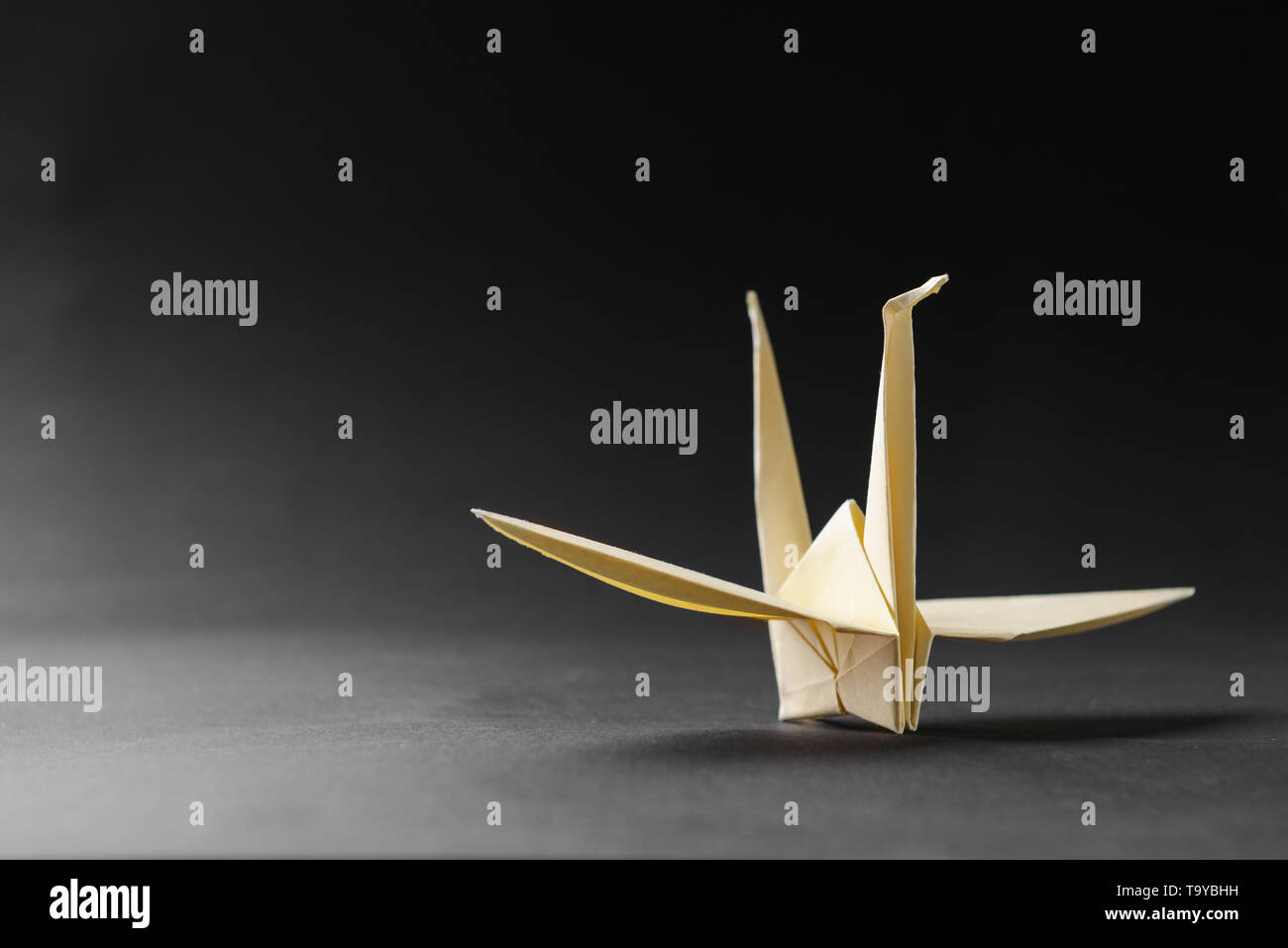 Origami crane on dark background Stock Photo - Alamy