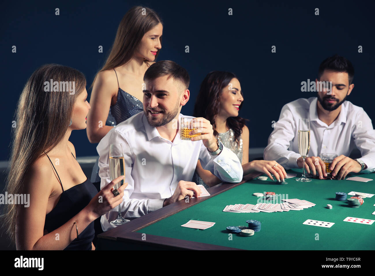 Group young people playing poker hi-res stock photography and images ...