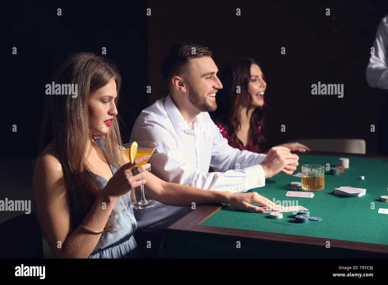 Group young people playing poker hi-res stock photography and images ...