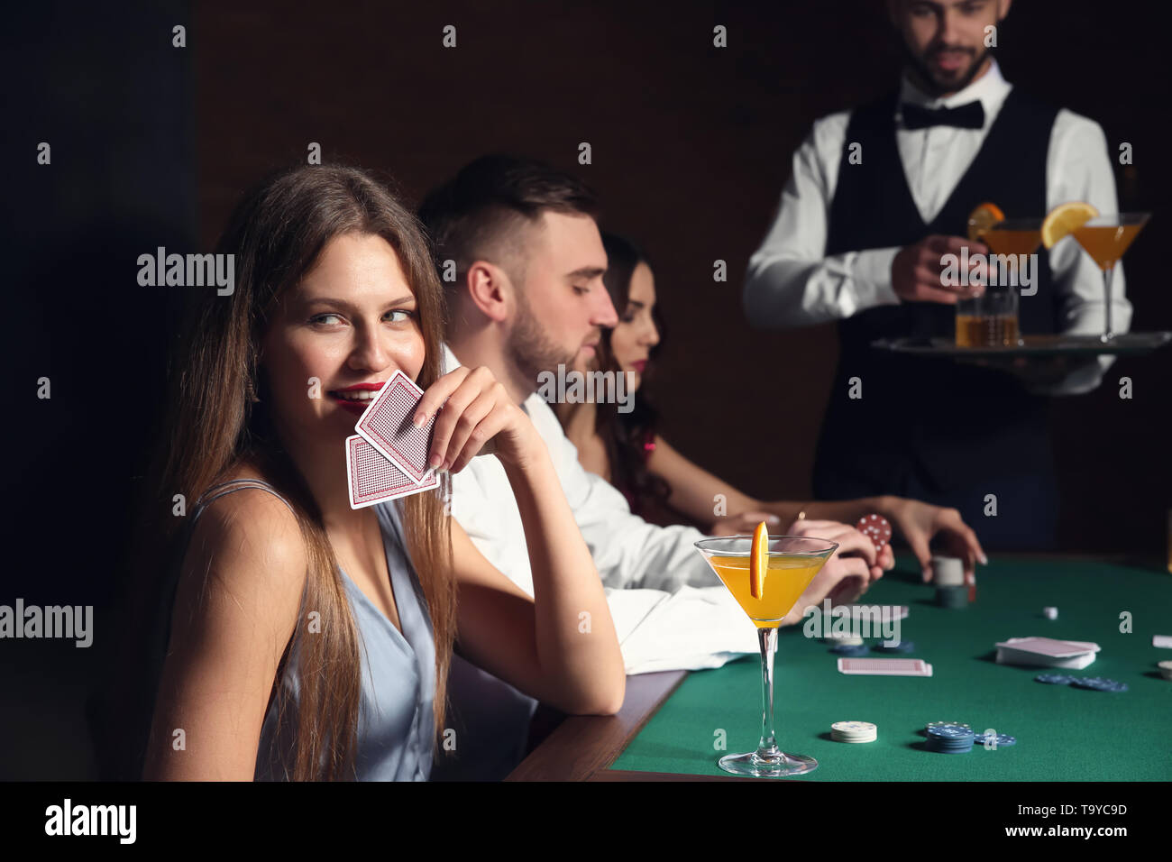 Group young people playing poker hi-res stock photography and images ...
