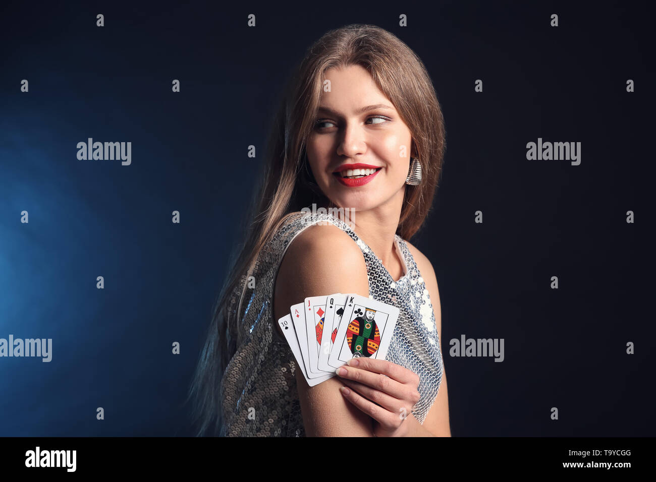 Beautiful young woman with cards on dark background Stock Photo - Alamy