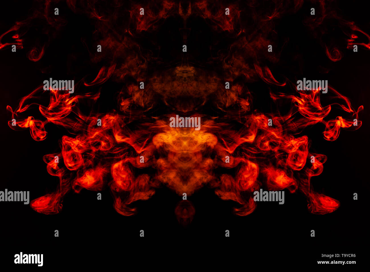 Smoke of different orange and red colors in the form of horror in the ...