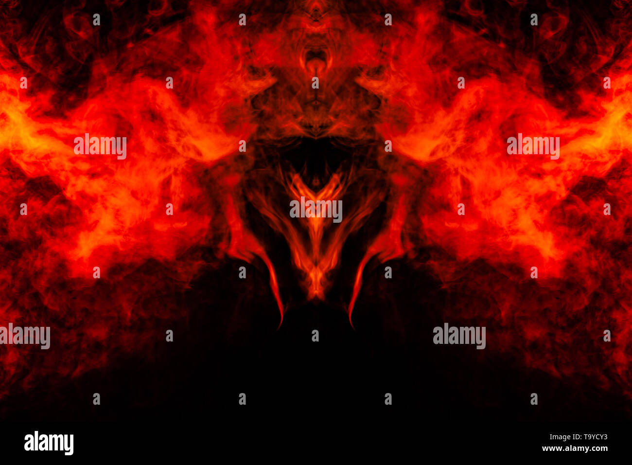 Smoke of different orange and red colors in the form of horror in the ...