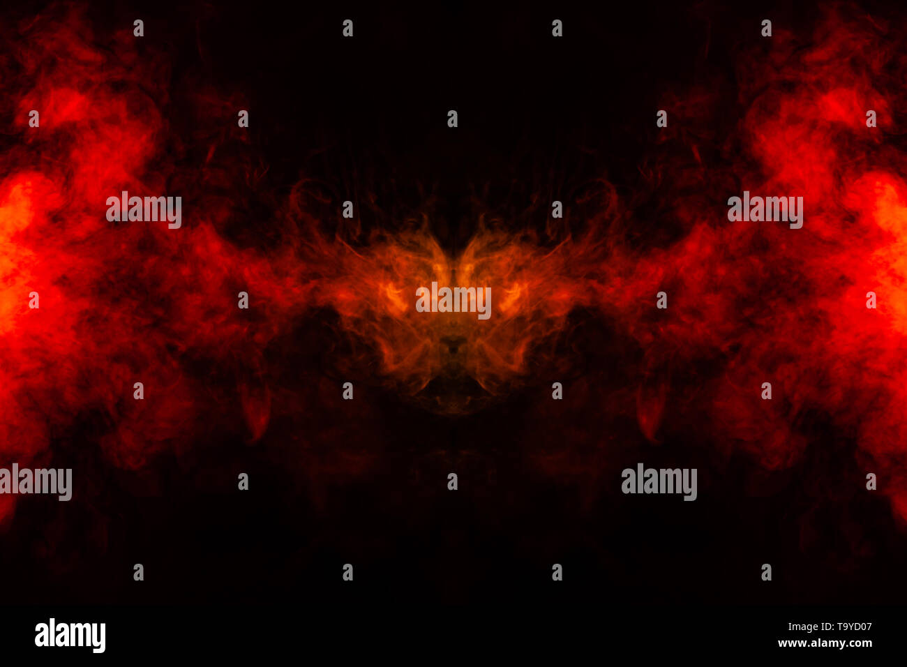 Smoke of different orange and red colors in the form of horror in the ...