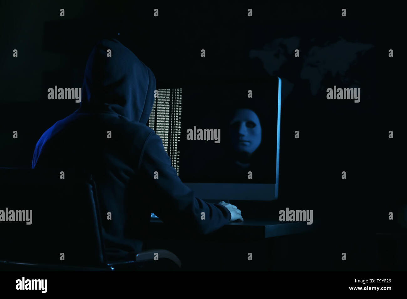 Professional hacker using computer in dark room Stock Photo - Alamy