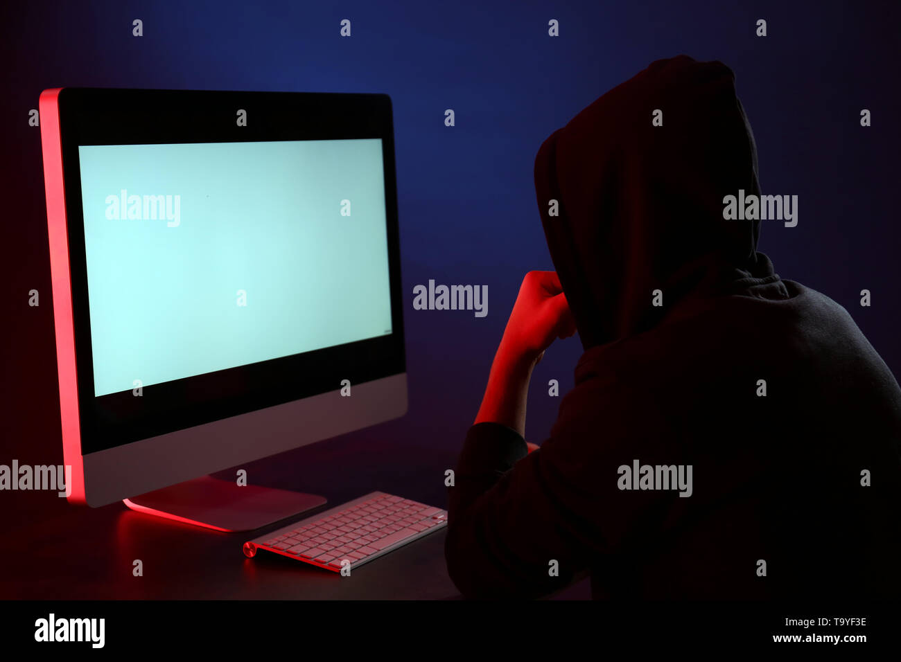 Professional hacker using computer on dark background Stock Photo - Alamy